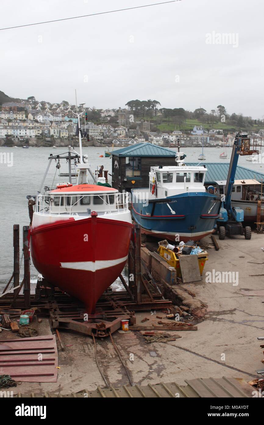 Working boatyard with two boats being worked on in Polruan, Cornwall ...