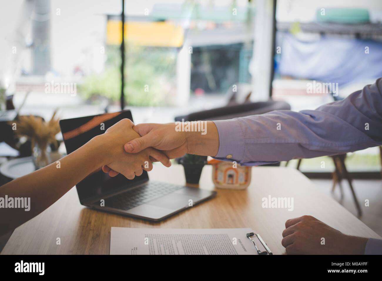 realtor & client handshaking. real estate agent shaking hands with ...