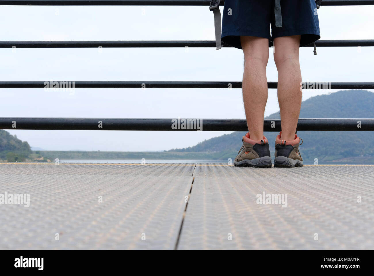 leg of traveler man with backpack travel at mountain & lake. tourist ...