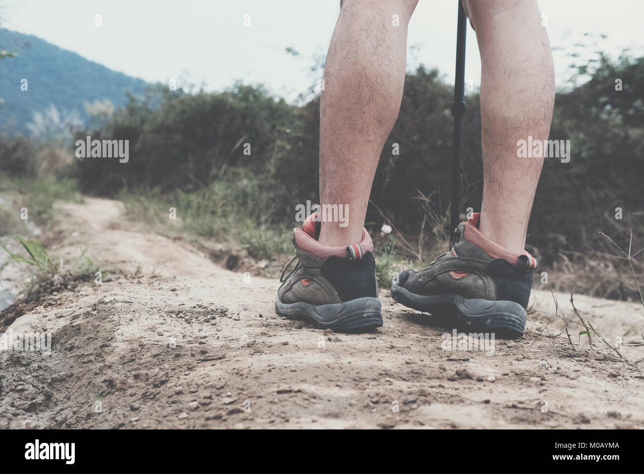 traveler hiker man with backpack hiking on mountain. leg of tourist ...