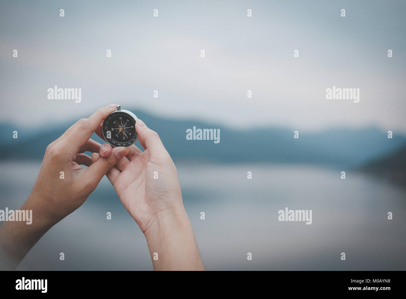 hands holding compass for searching direction outdoor. man seeking way ...