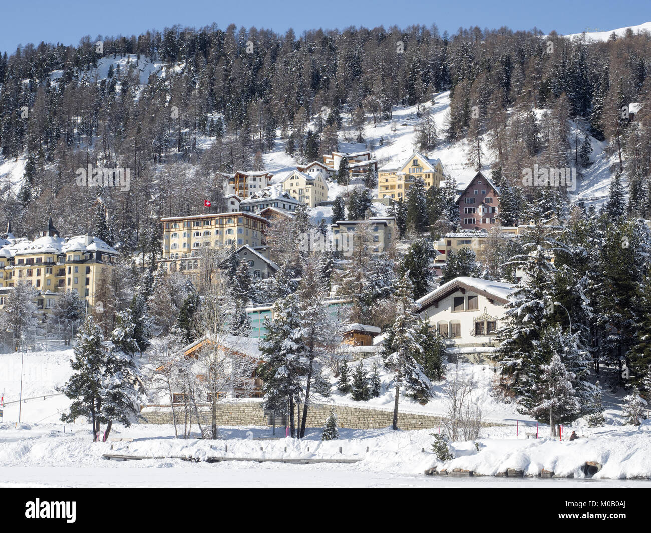 Saint Moritz town buildings during winter with snow and sun Stock Photo ...