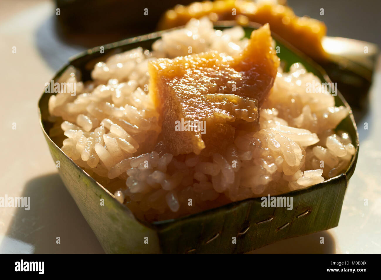 Thai sticky rice topped with fish Stock Photo - Alamy