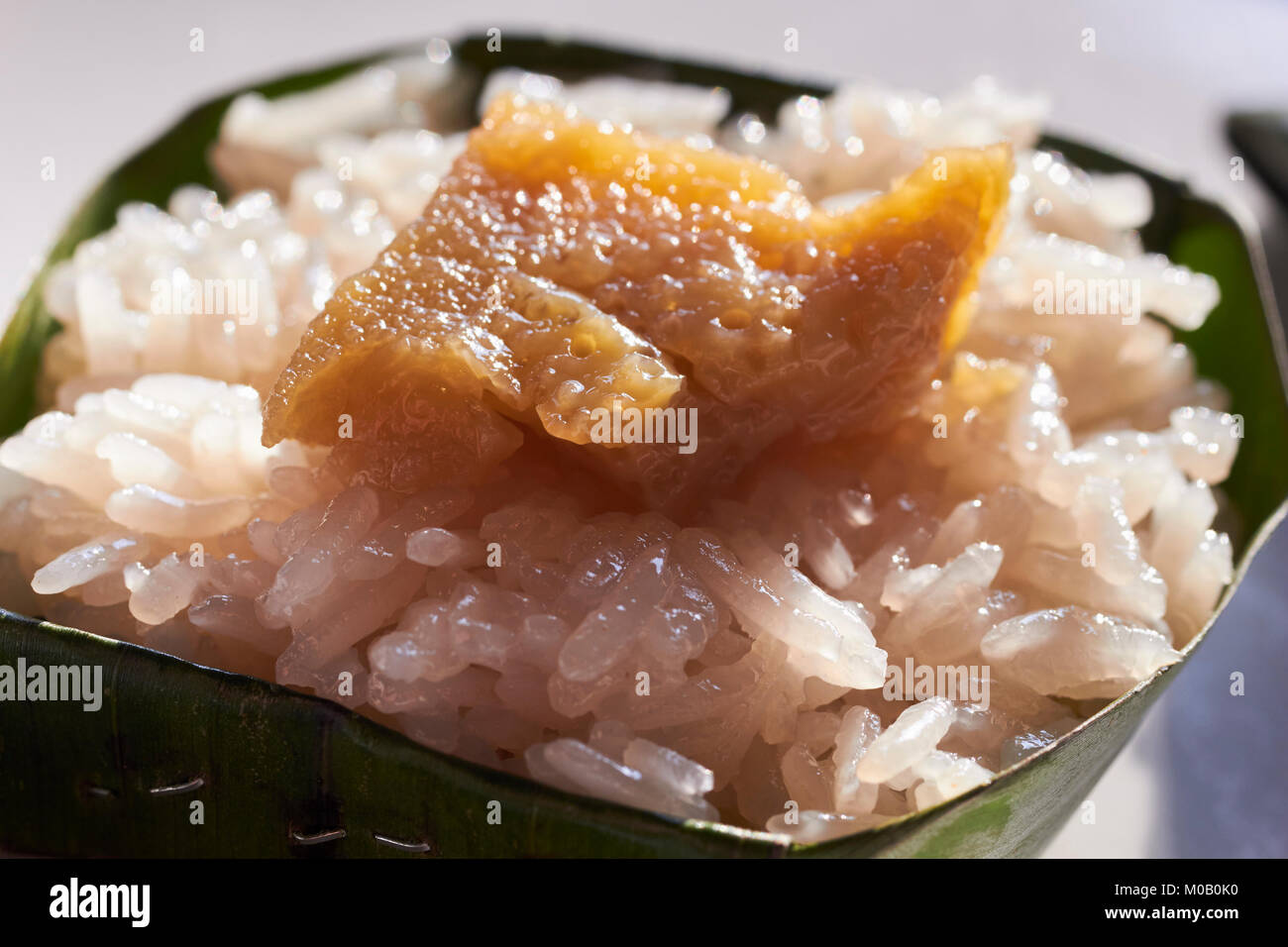 Thai sticky rice topped with fish Stock Photo - Alamy