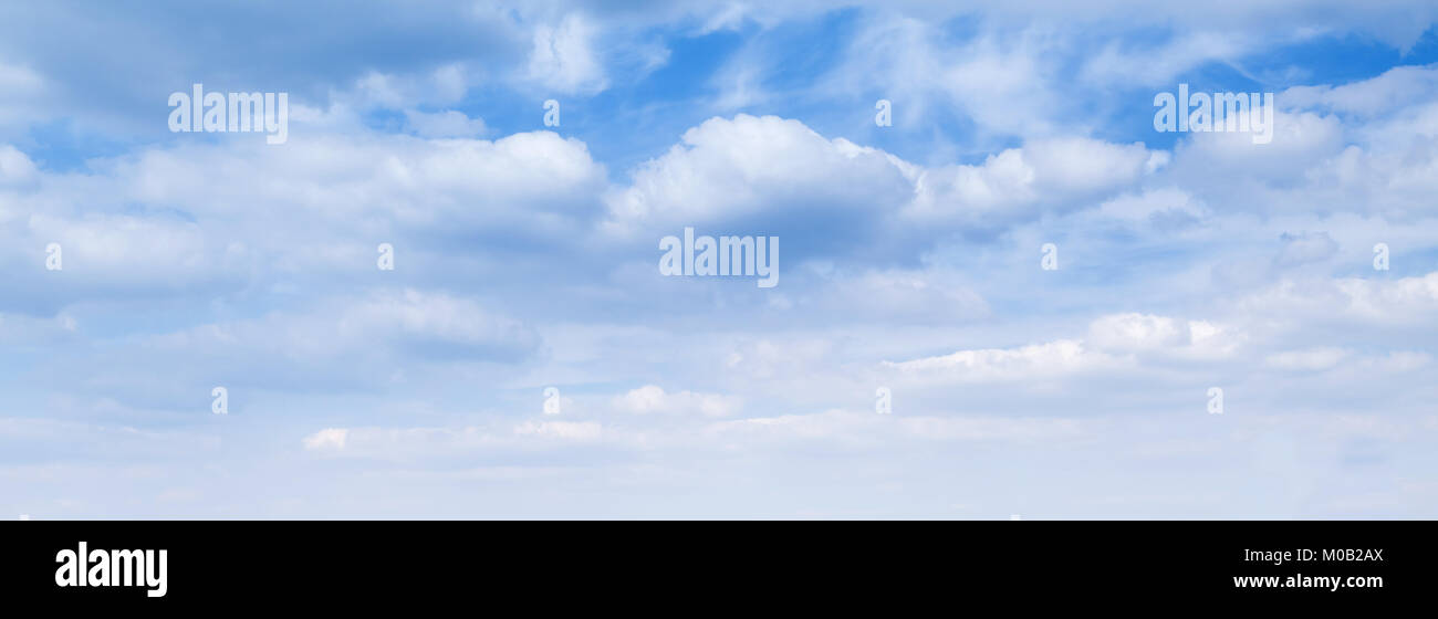 Wide blue sky background, natural panorama with white cumulus clouds ...