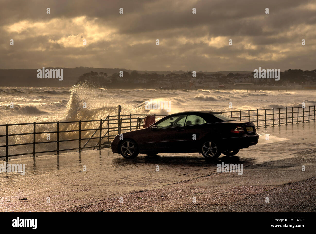 A car parked on the seafront during a stormy high tide Stock Photo - Alamy