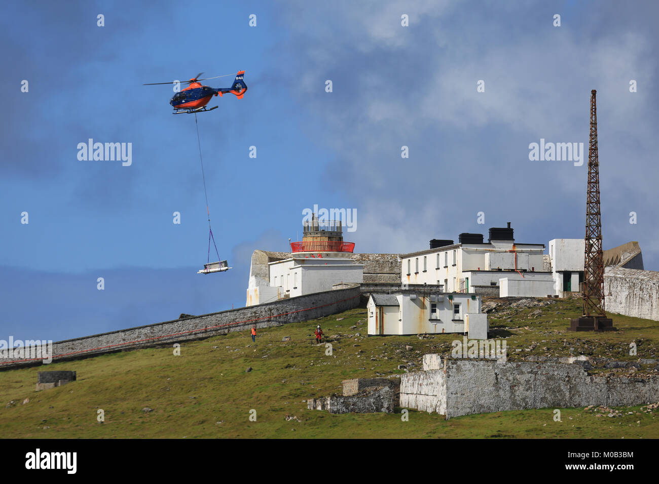 helicopter airlifting building material from an off shore irish island ...