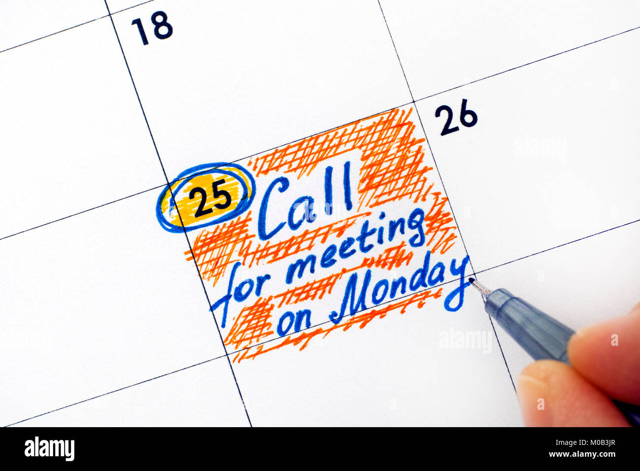 Woman fingers with pen writing reminder Call for meeting on Monday in ...