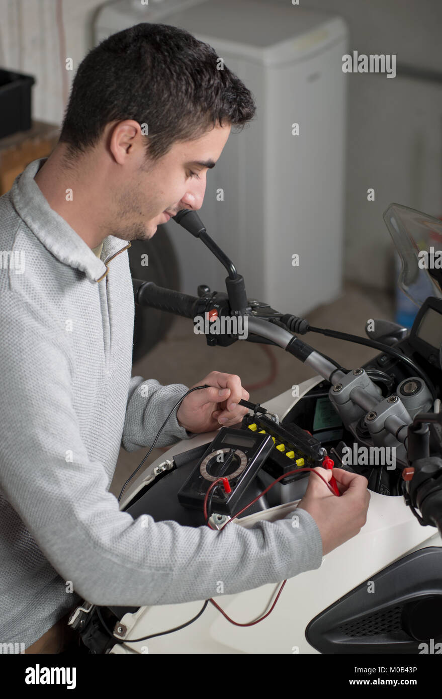 a testing the battery of the motorcycle Stock Photo - Alamy