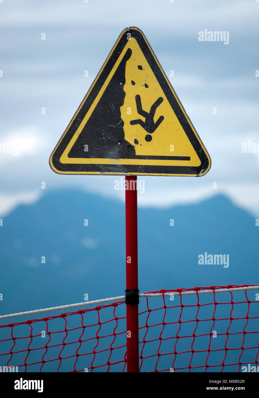 A sign indicating the danger of falling in the mountains Stock Photo ...