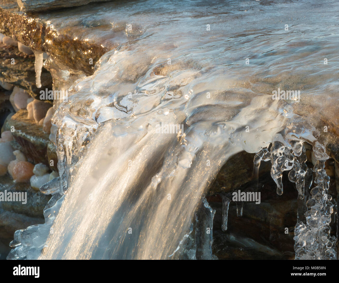 Water flowing over a waterfall despite ice formed all over Stock Photo ...