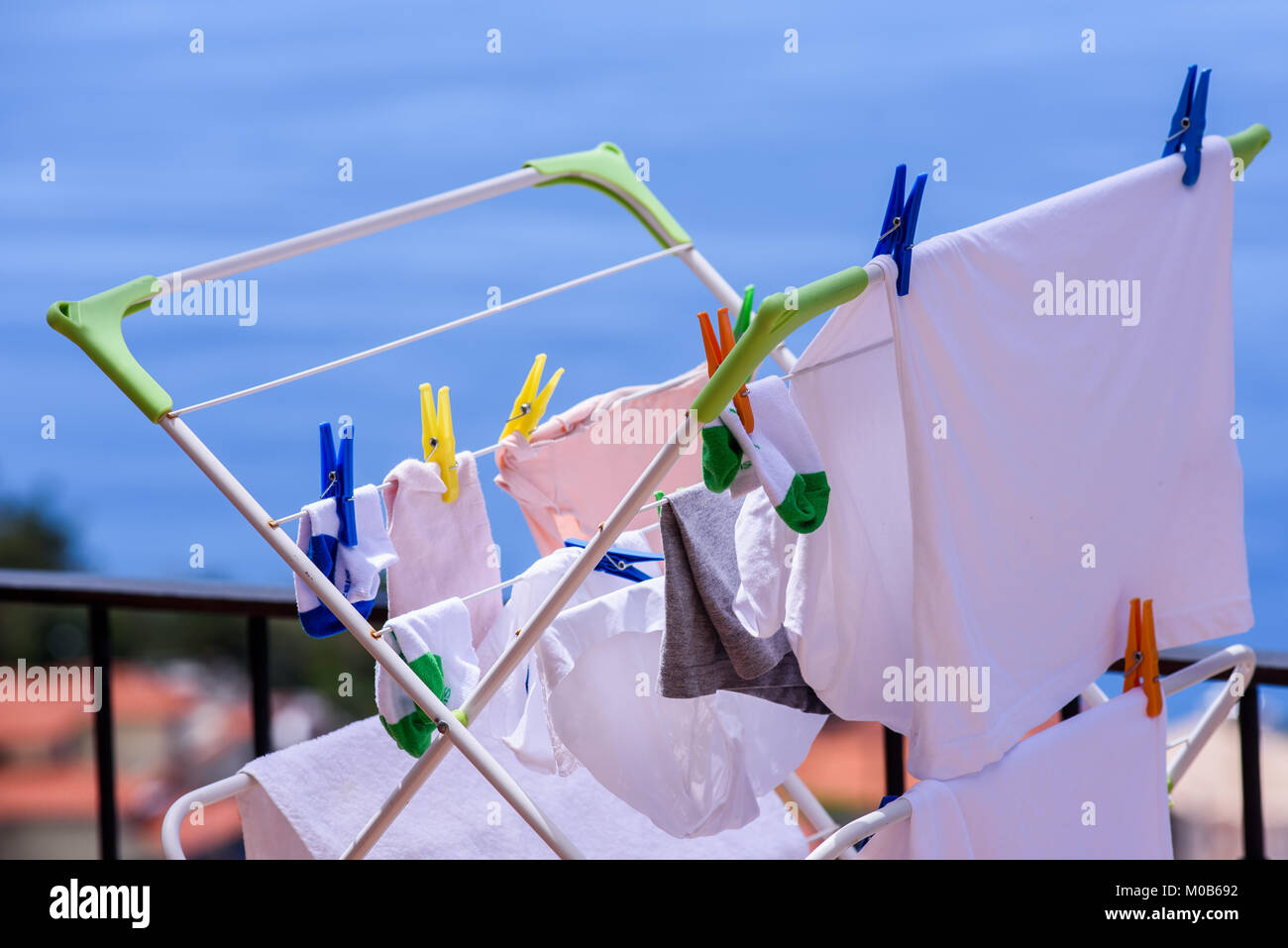 Clothes drying with clothes peg on balcony Stock Photo - Alamy