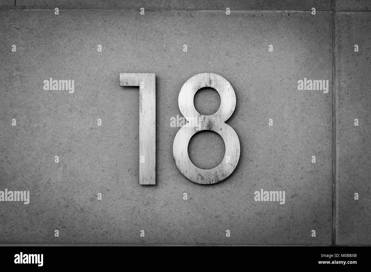 Number 18 on a slate wall Stock Photo - Alamy