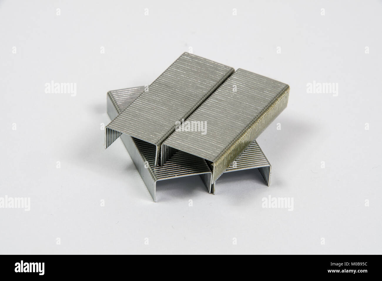 Stack of metal staples on a white background Stock Photo - Alamy