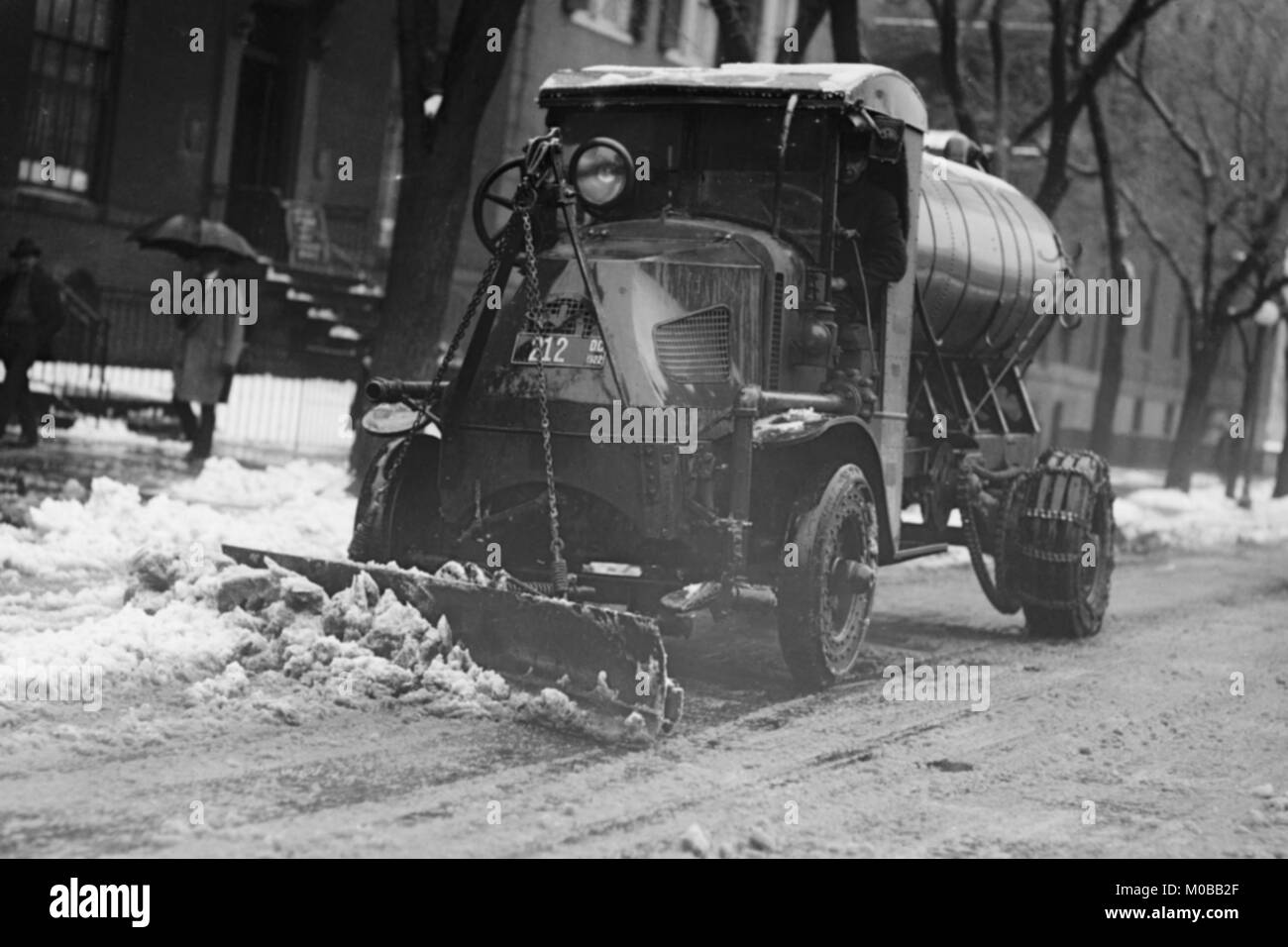 Tank Truck with Snow Plow Cleans the Streets Stock Photo - Alamy