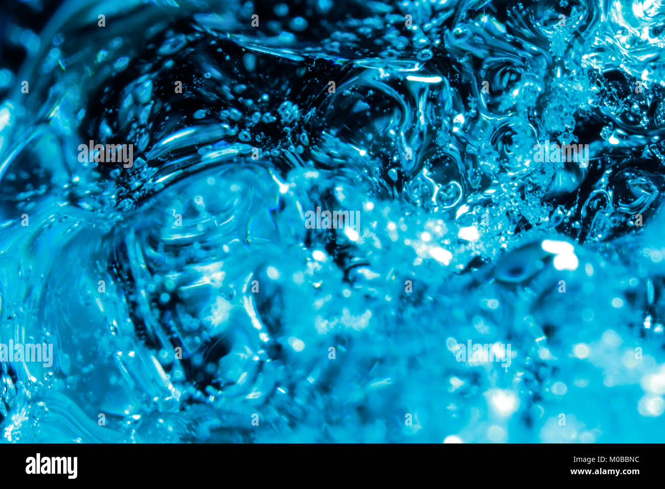 Frozen water bubbles in turquoise ice. A small iceberg in the water ...