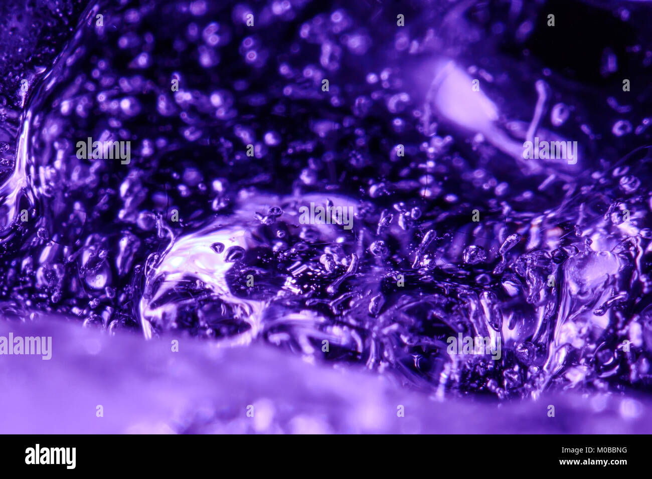 Violet ice with frozen bubbles in the water. A small iceberg in the ...