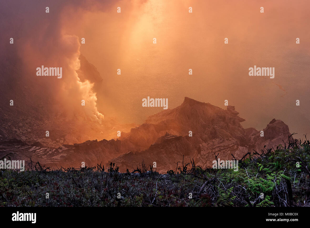 Toxic sulphur smoke emission from volcano at sunset, Ijen, Indonesia ...
