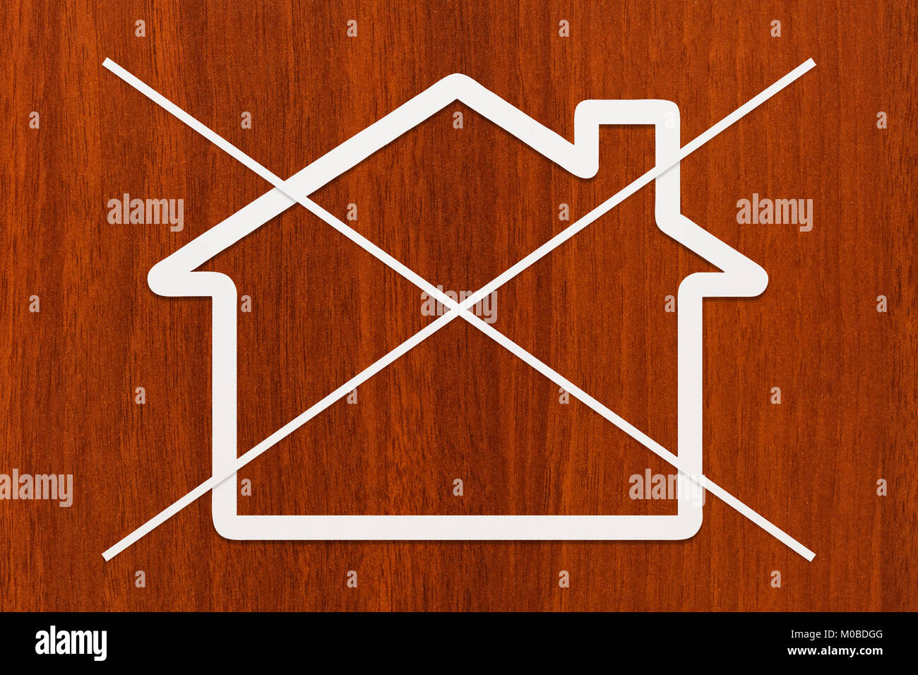 Strikethrough paper house on wooden background. Abstract conceptual ...