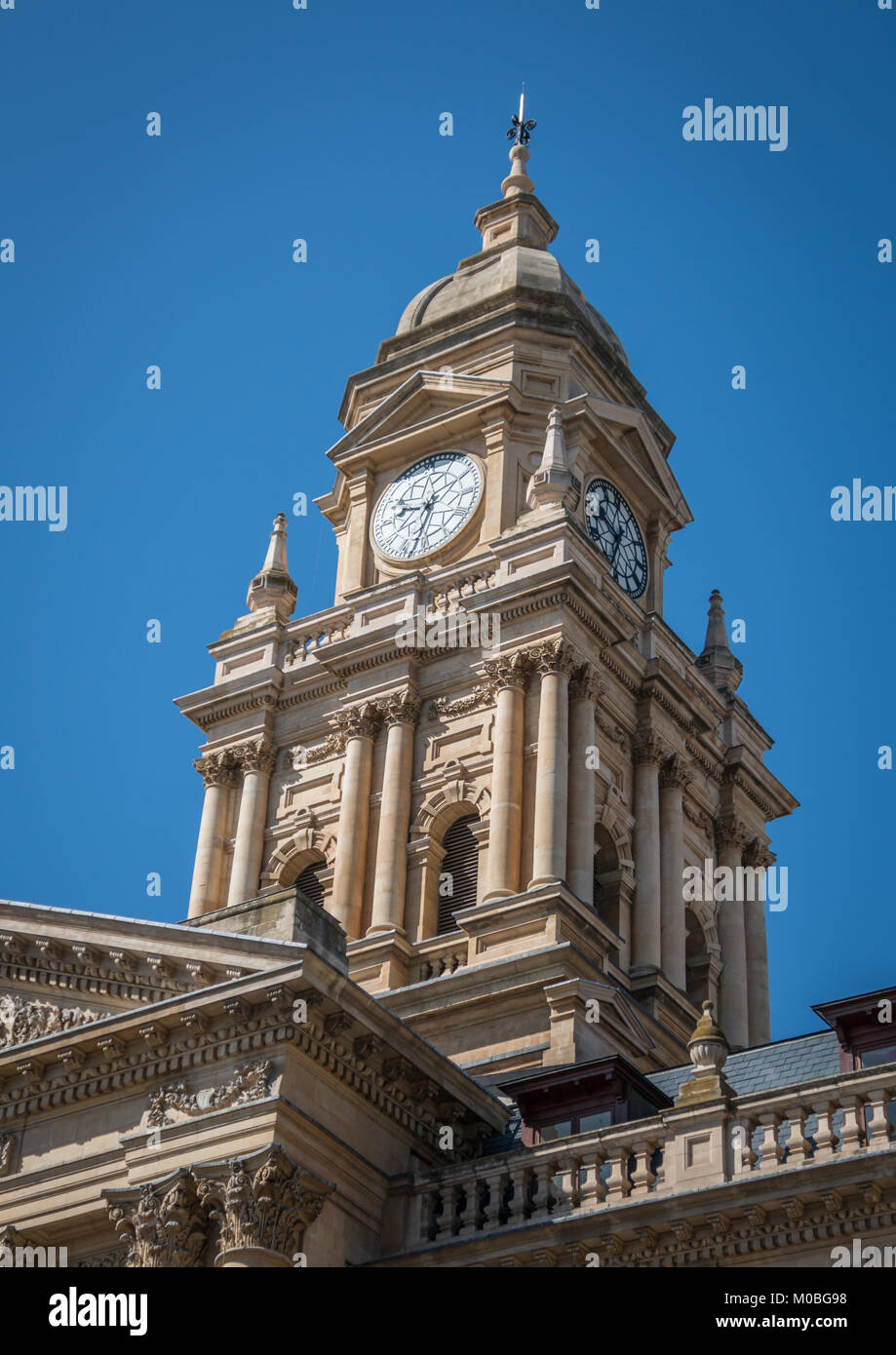 Limestone edwardian clock tower on blue sky background Stock Photo - Alamy
