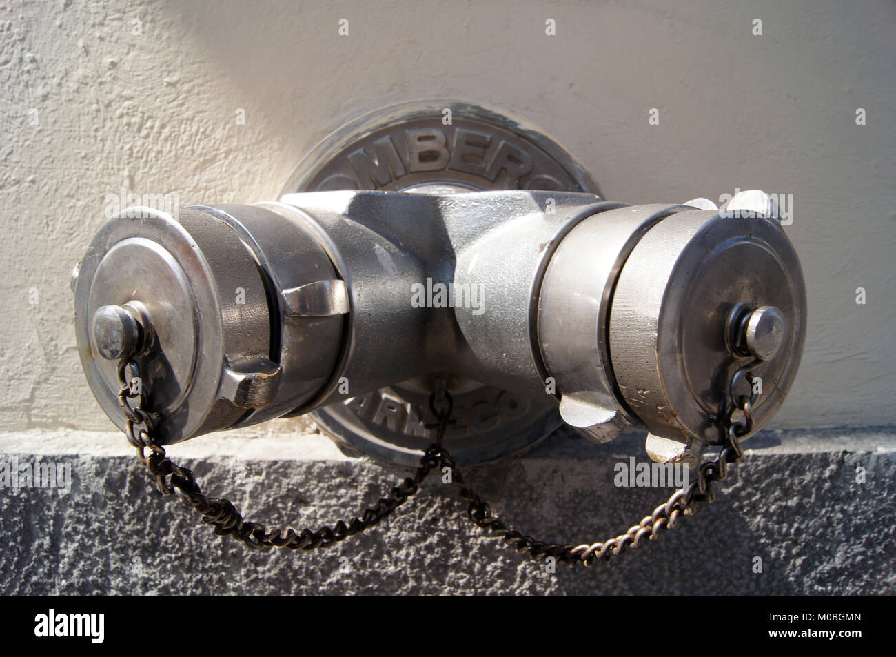 Pipe on the wall with chain in Mexico Stock Photo - Alamy