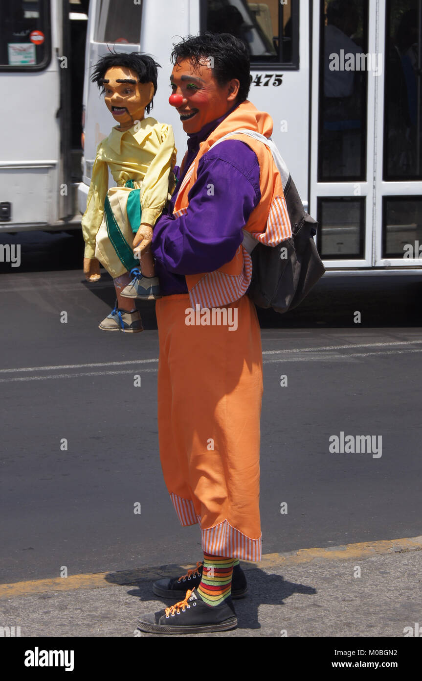 Clown with puppet on the street near the bus Stock Photo - Alamy