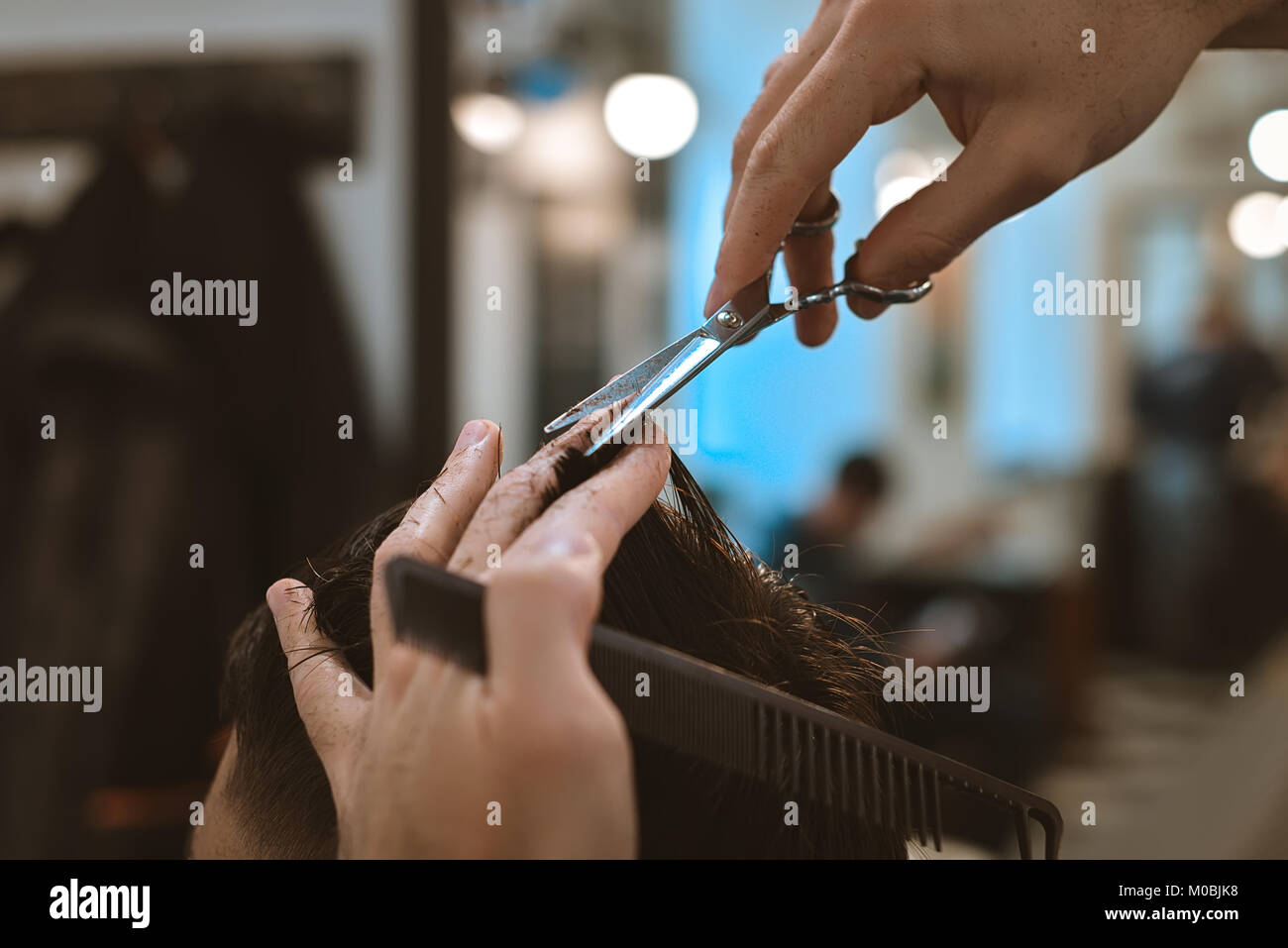 Closeup of smiling man getting an haircut from barber Stock Photo - Alamy