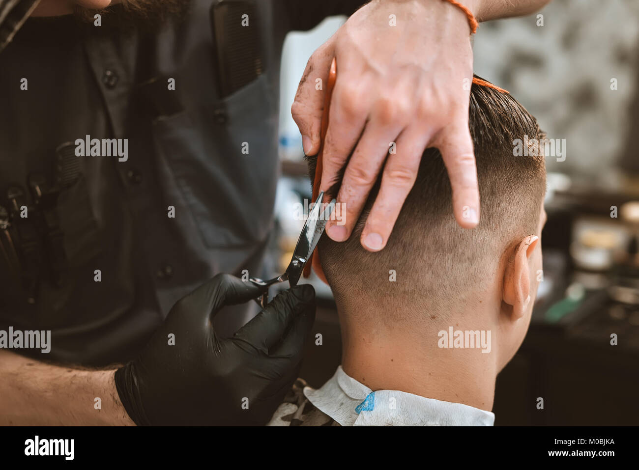 Closeup of smiling man getting an haircut from barber Stock Photo - Alamy