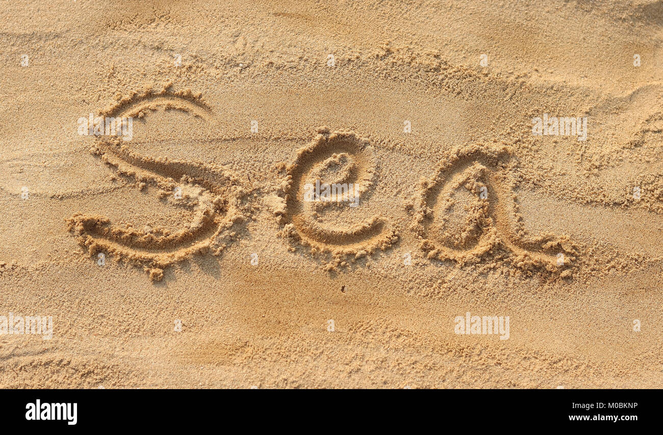 Sea - sand writing on the beach Stock Photo - Alamy
