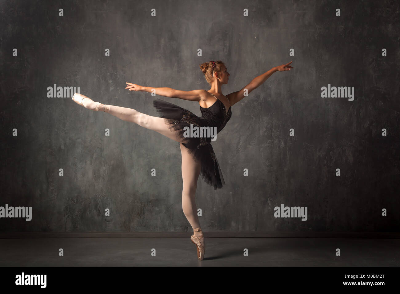 Beautiful attractive blonde woman primer ballerina in a black dance ...