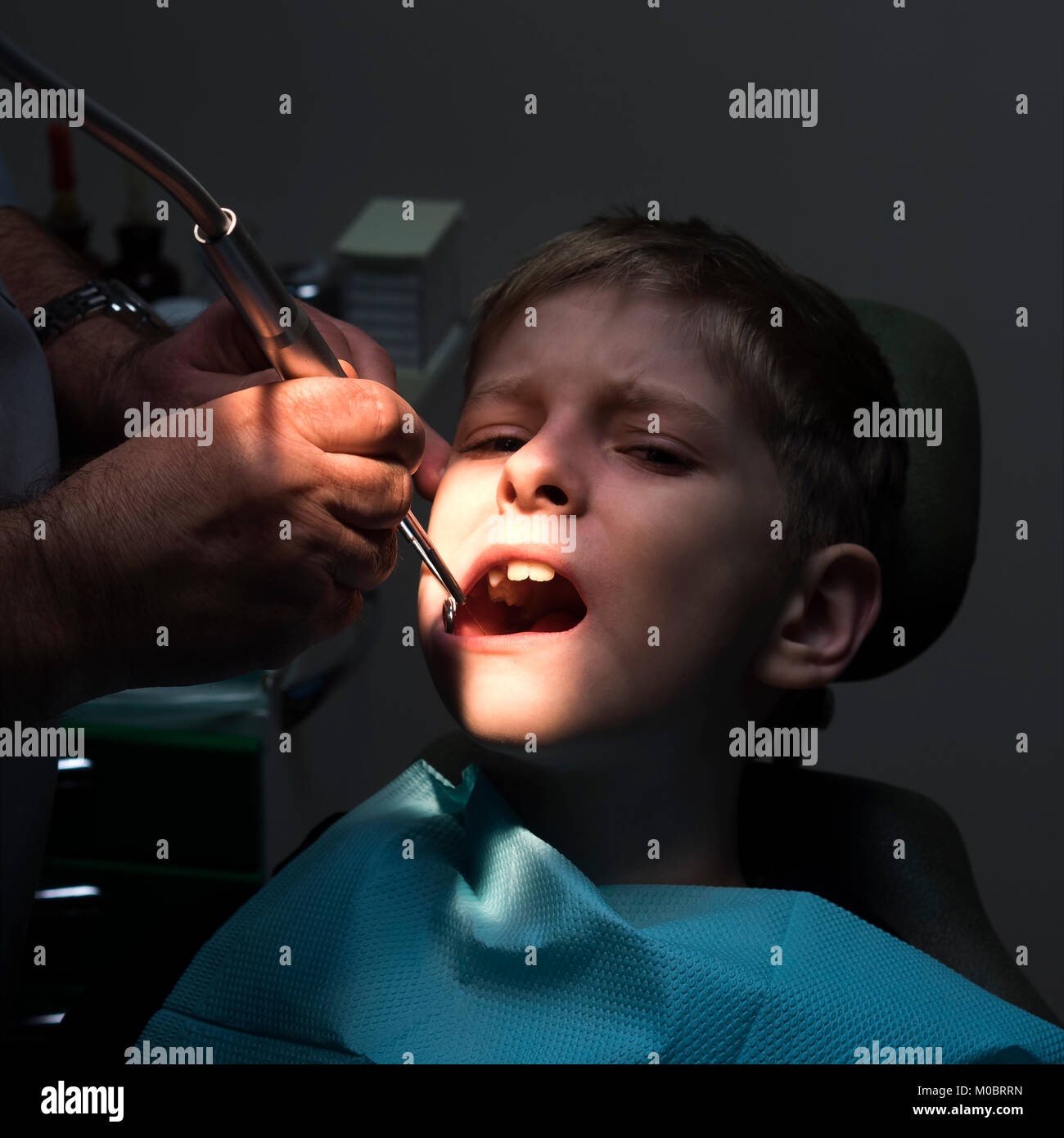 dentist heals the teeth of caucasian boy Stock Photo - Alamy