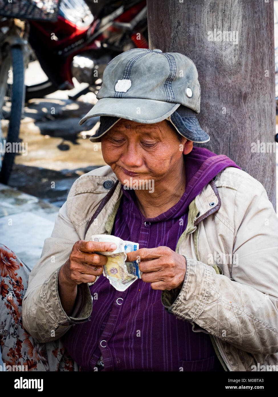 Mentally ill lady begging on the streets of Hoi An Stock Photo - Alamy