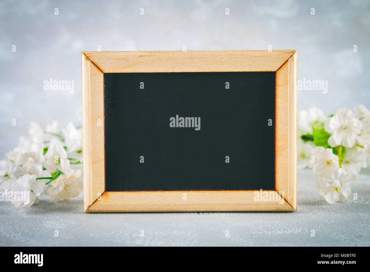 Chalkboard in a wooden frame with an empty box surrounded by white ...