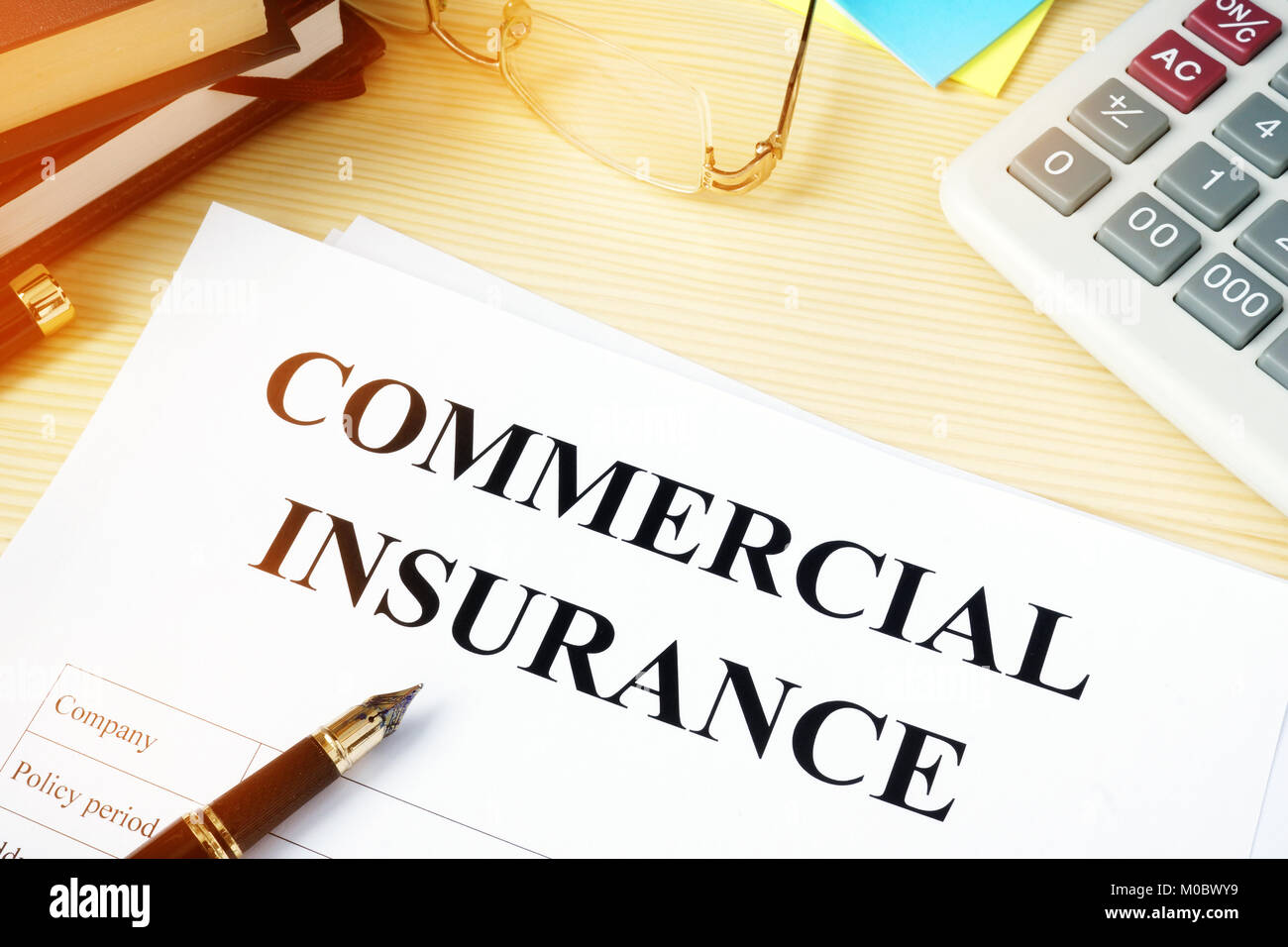 Commercial insurance policy on an office desk Stock Photo - Alamy