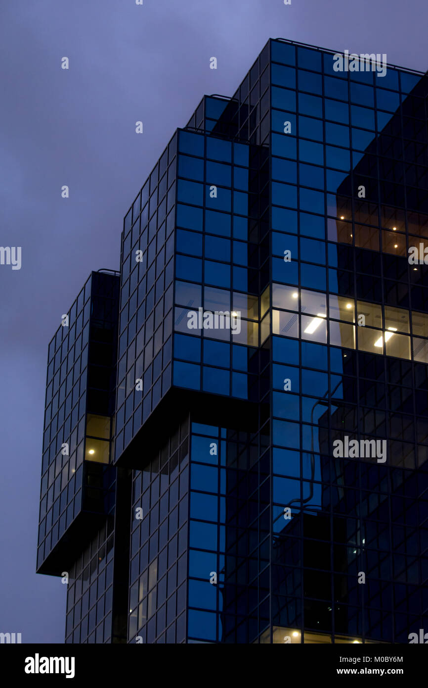 Office building exterior at night with some lights on Stock Photo - Alamy