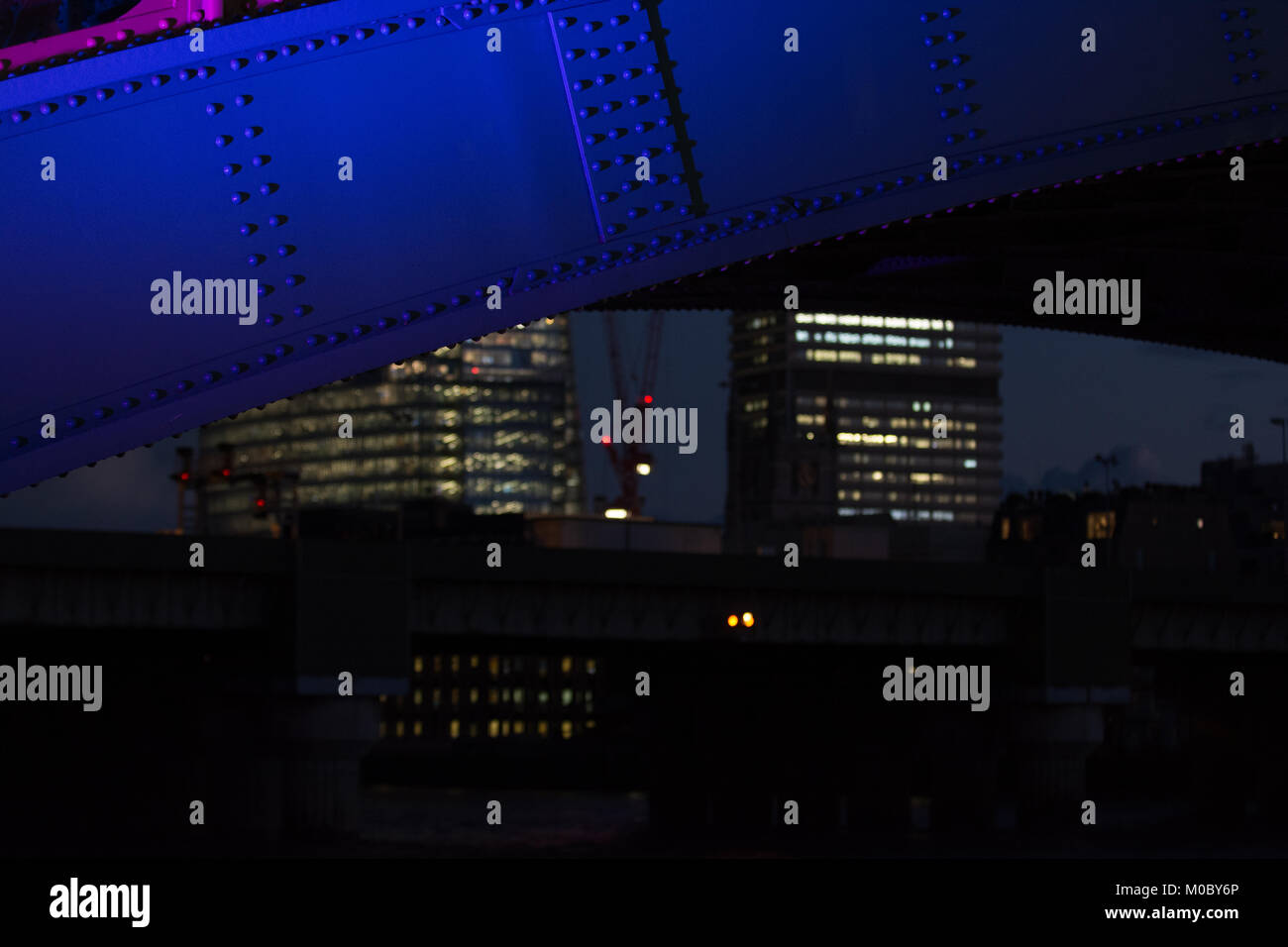 Night scene in a city view under a bridge of city buildings Stock Photo ...