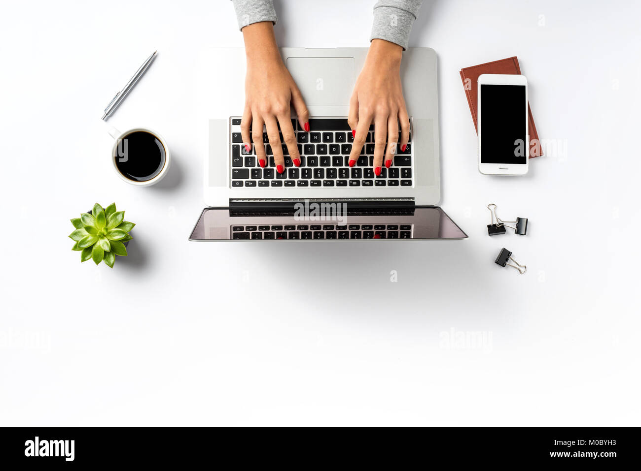 Female hands working on modern laptop. Office desktop on white ...