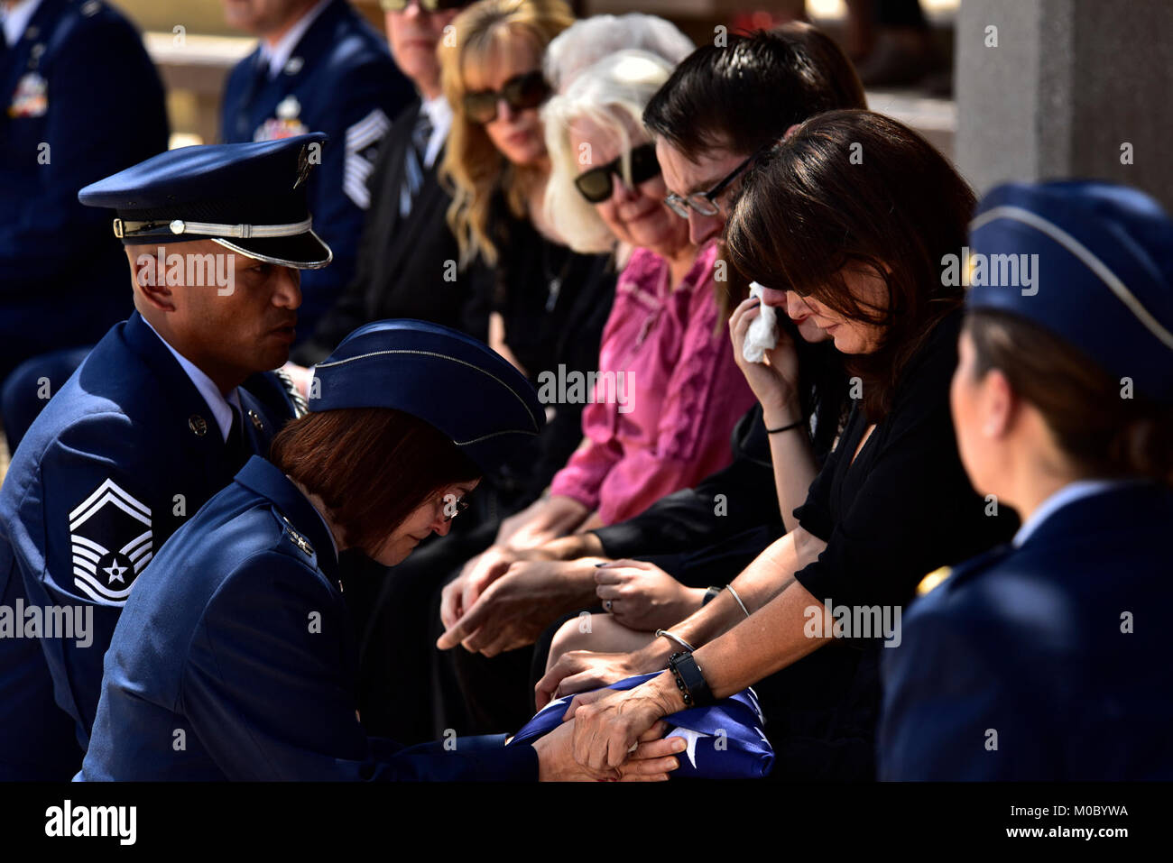 163d Attack Wing vice commander Col. Carrie Colas presents a folded ...