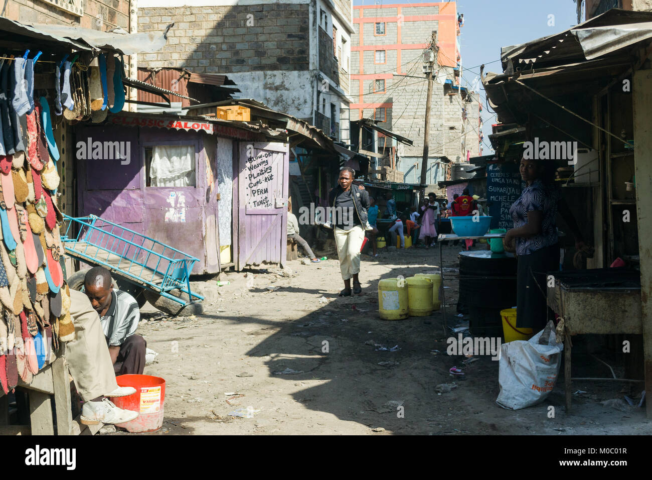 View down a small road in Huruma, showing small shops and people ...