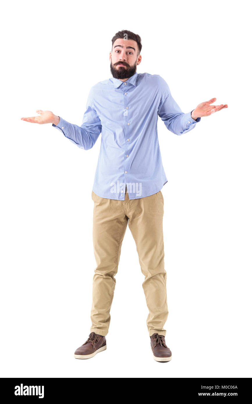 Confused young bearded businessman shrugging shoulders looking at ...