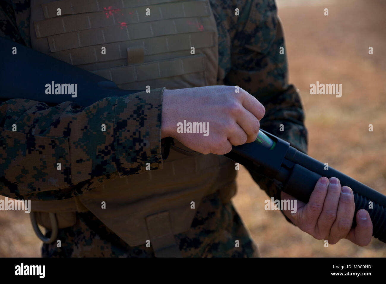 U.S. Marine Corps Sgt. Jeffrey Rychener, a non-lethal weapons ...