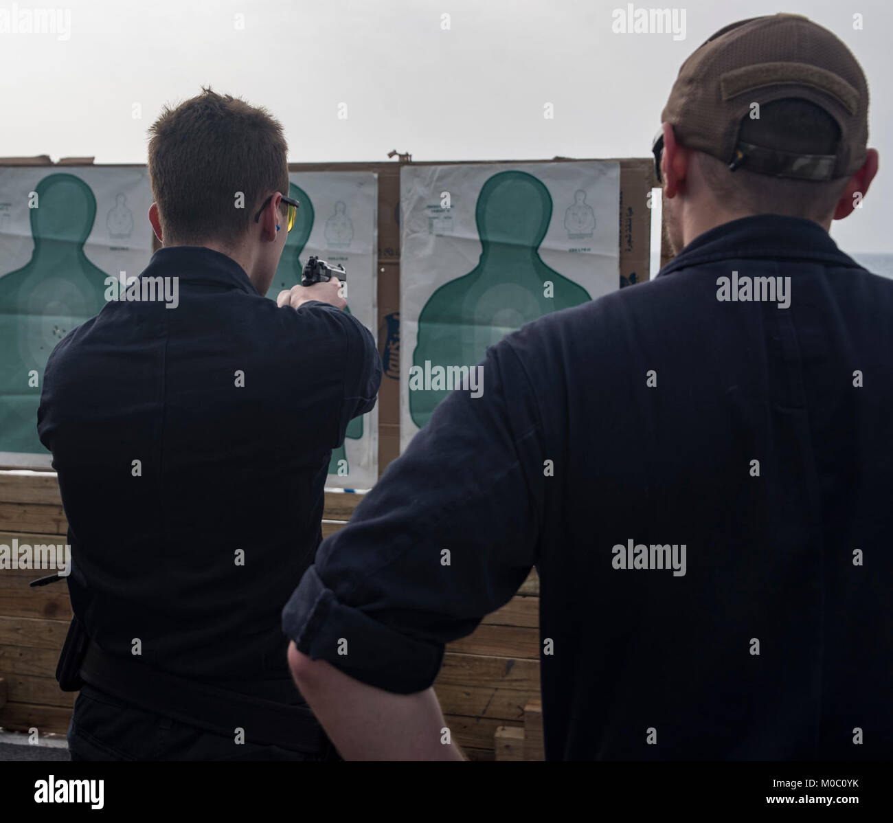 GULF OF OMAN (Dec. 9, 2017) Gunner's Mate Seaman Tyler Pilon fires a 9 ...