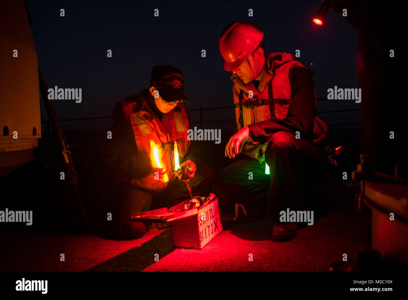 ARABIAN GULF (Dec. 12, 2017) Gunner's Mate 2nd Class Devan Vick, left ...