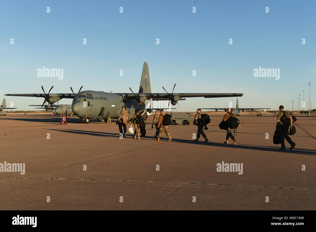 U.S. Air Force Airmen assigned to the 317th Airlift Wing begin boarding ...