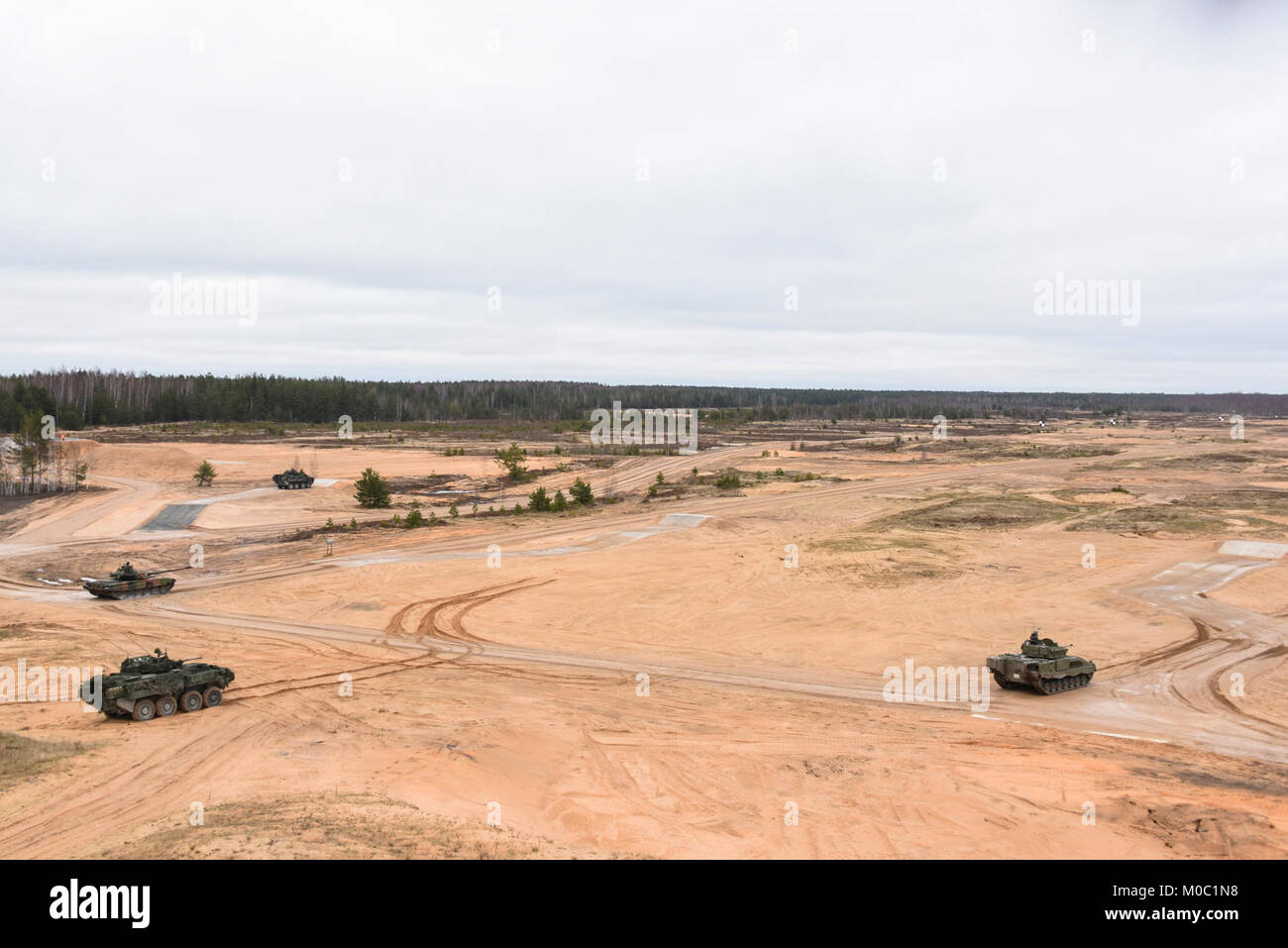 Spanish, Polish and Canadian soldiers and their vehicles test a newly ...