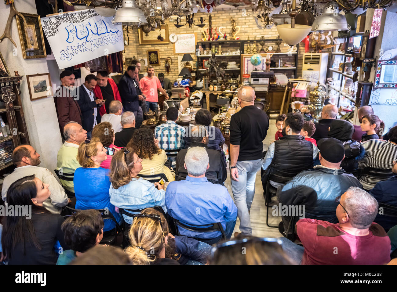 Unidentified man selling antique objects in auction shop in Balat ...