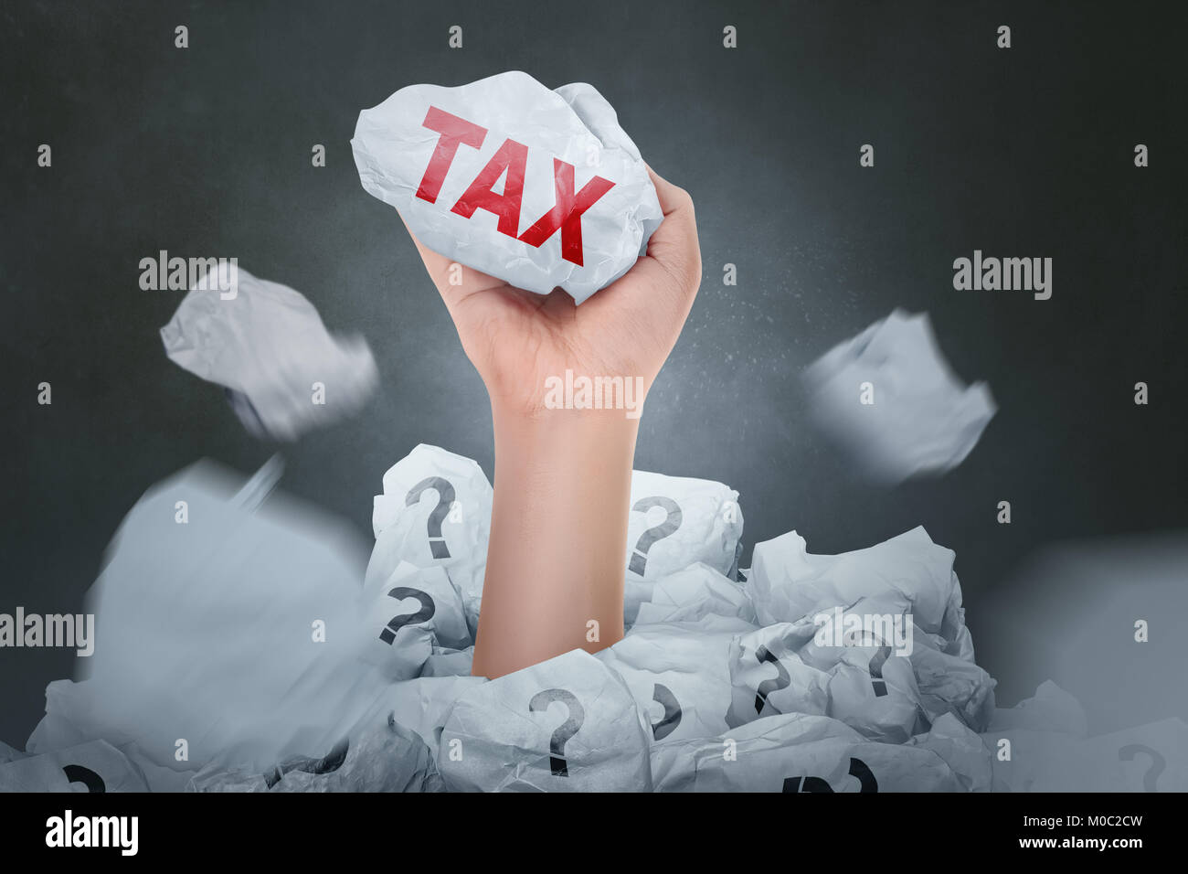 People hand holding paper with Tax sign over dark background Stock ...