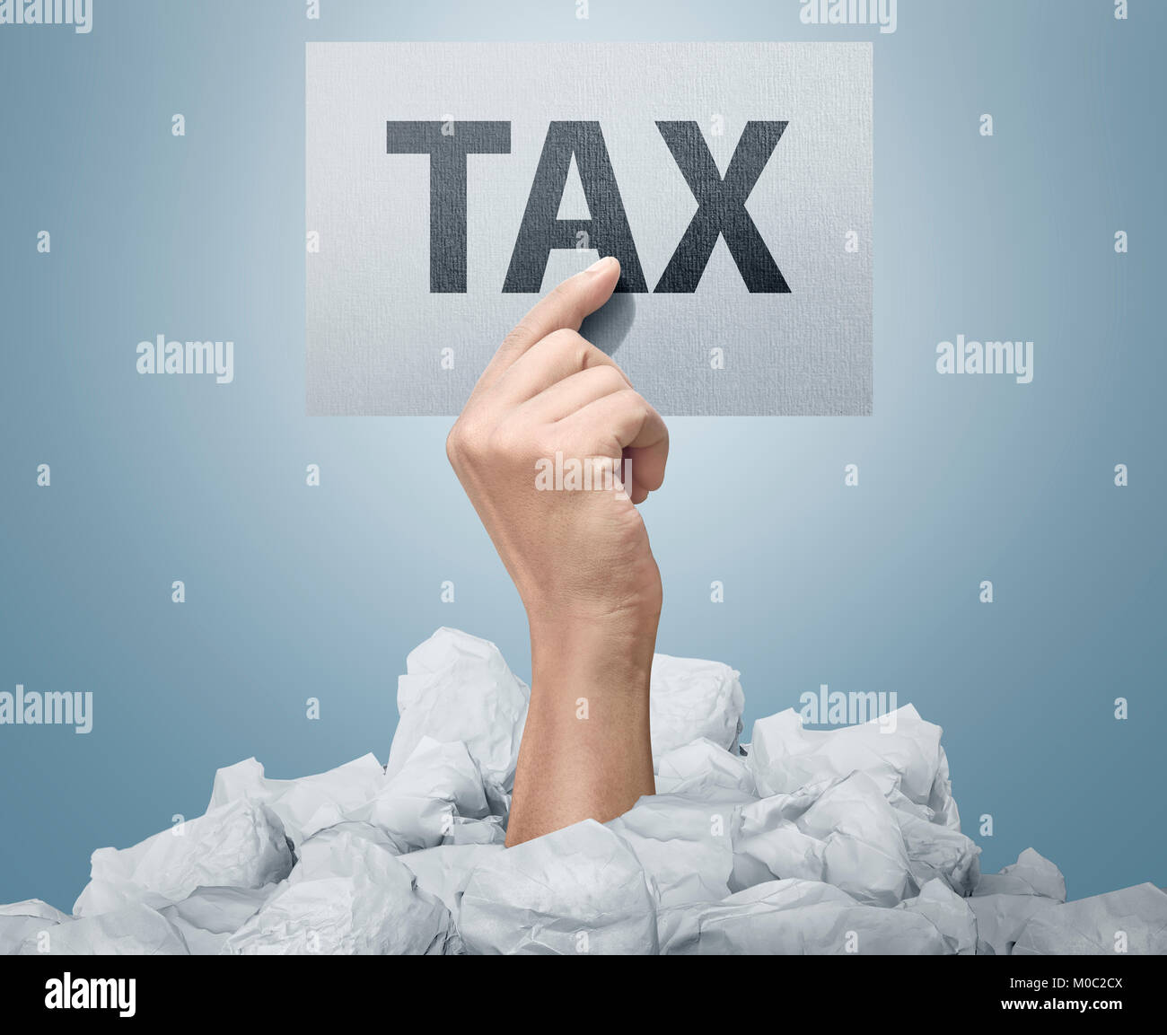 People hand holding paper with Tax sign over bright background Stock ...