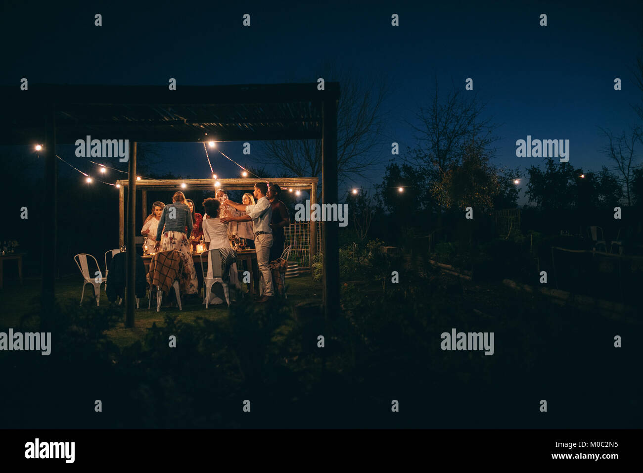 Group of people having a party at night. Friends enjoying party in ...