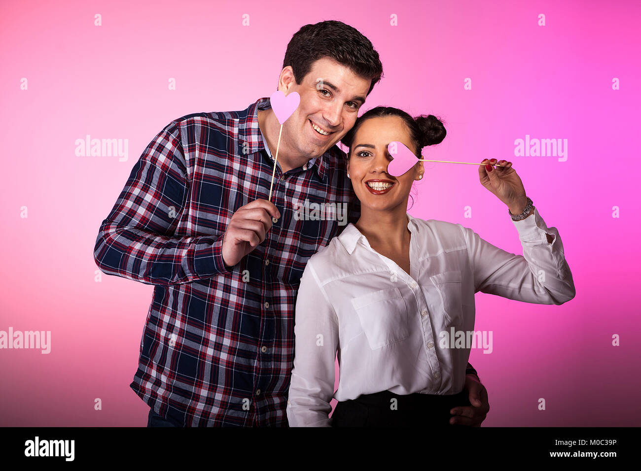 Happy inlove couple with pink hearts in their hands Stock Photo - Alamy